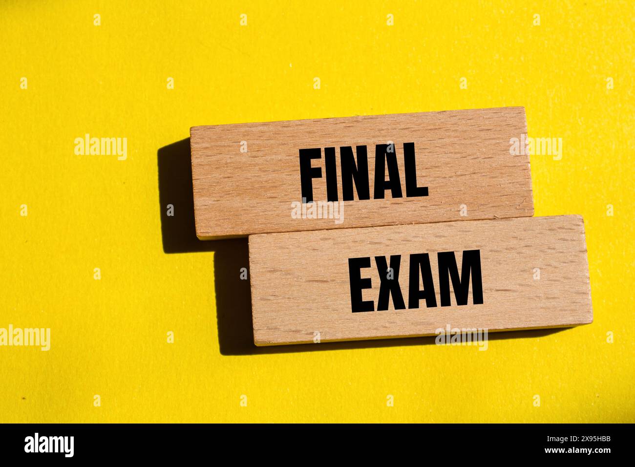 Final exam words written on wooden blocks with yellow background ...