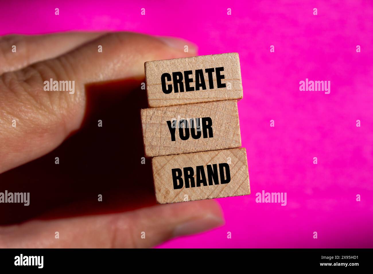 Create your brand words written on wooden blocks with pink background ...