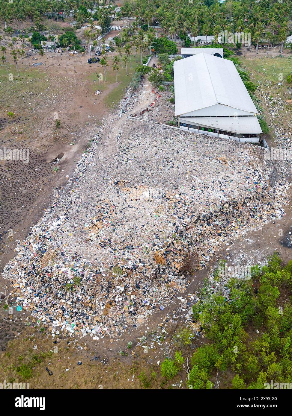 Drone view of a huge, dirty open air garbage dump on Indonesias Gili ...