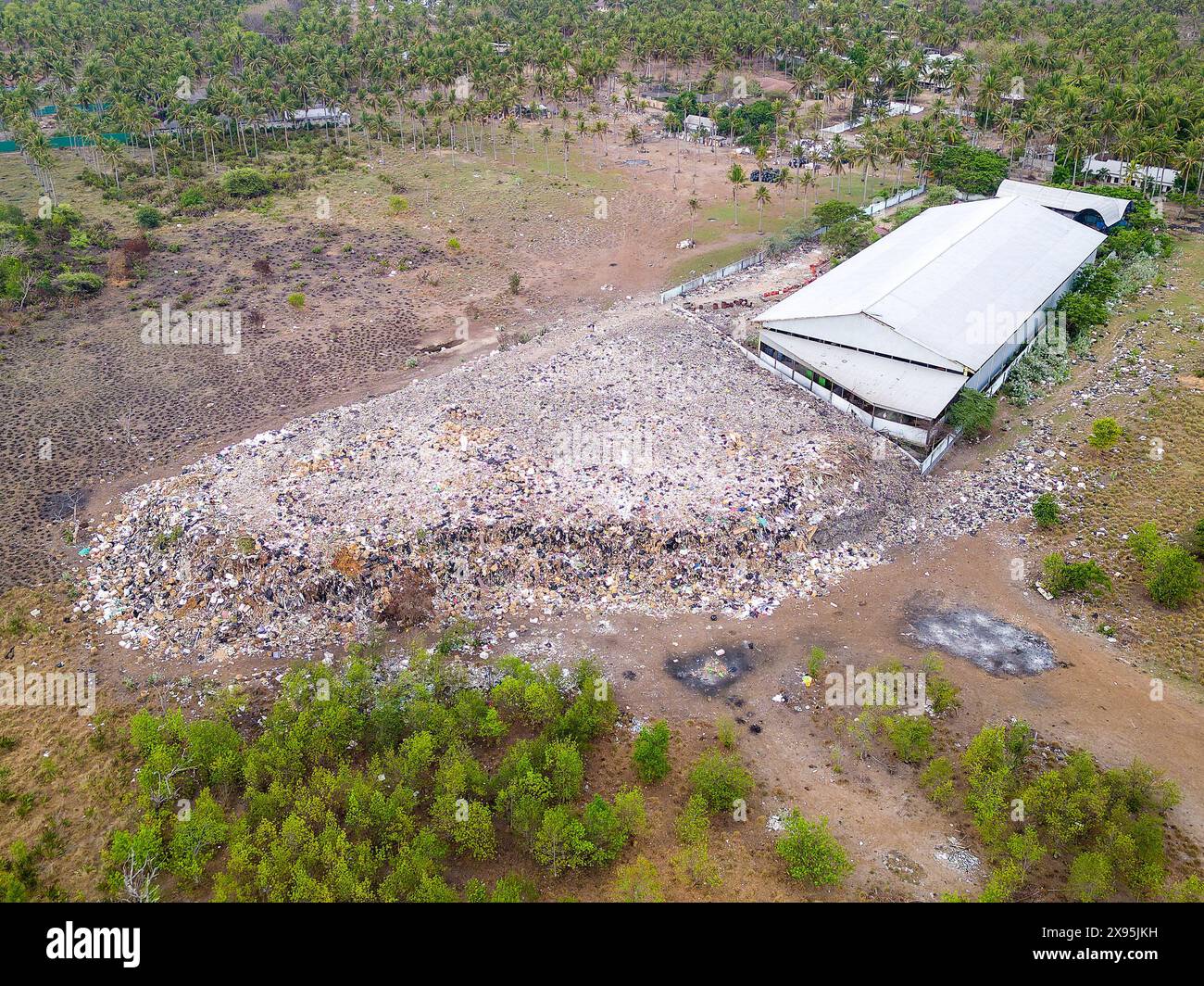 Aerial view of a huge, open air garbage dump full of plastic and ...