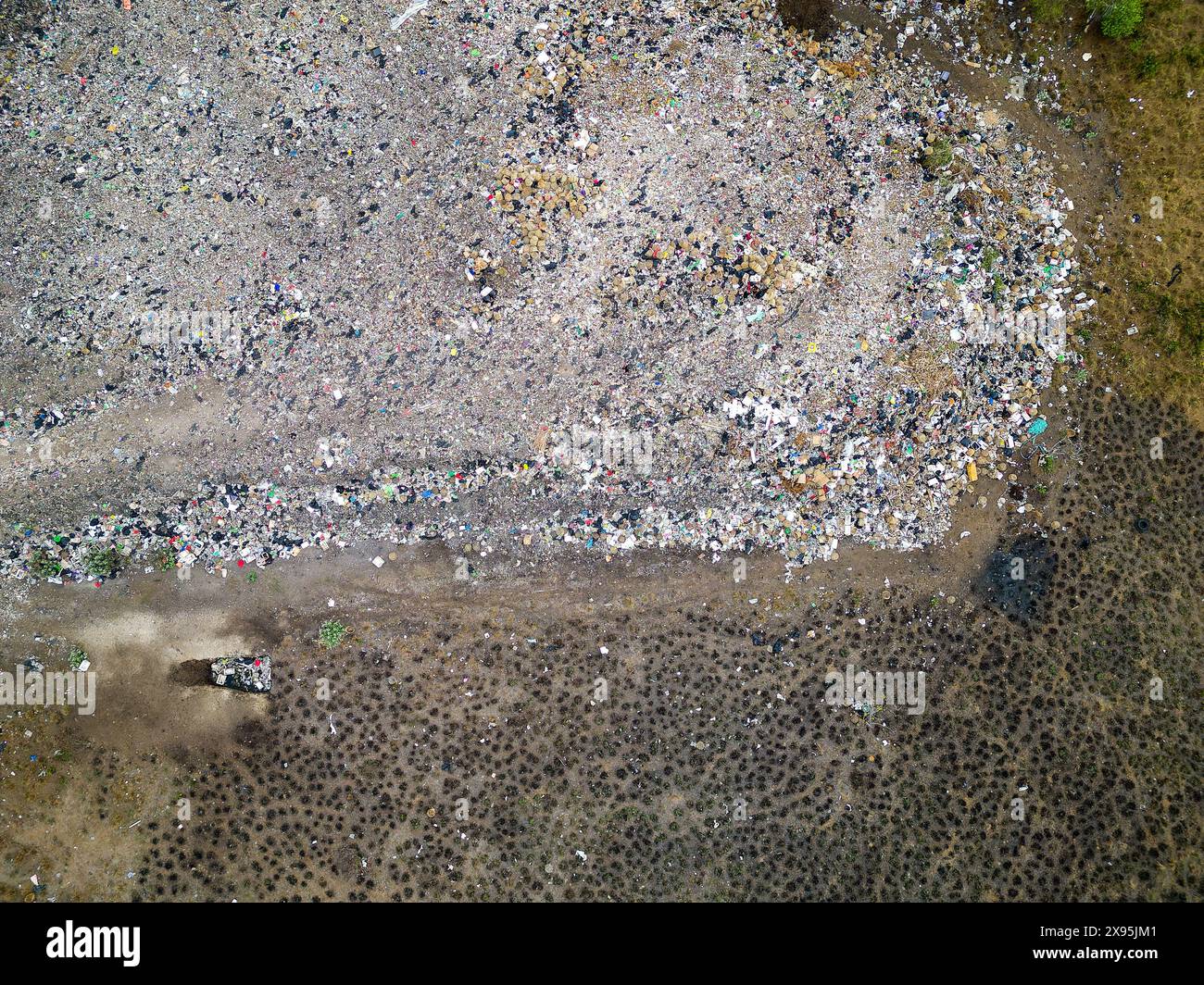 Aerial view of a huge, open air garbage dump full of plastic and ...
