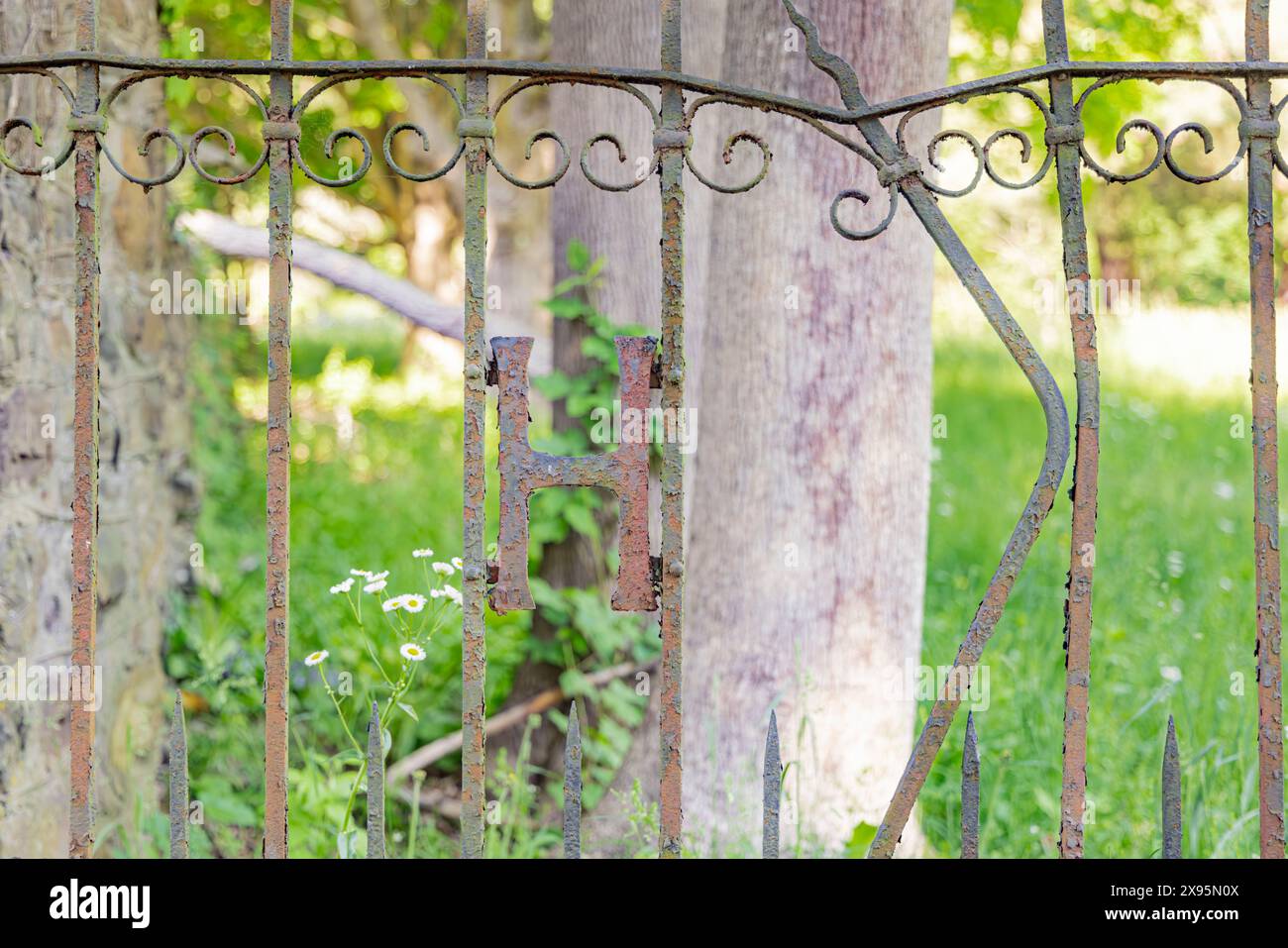 old rusted wrought iron gate with the letter H Stock Photo - Alamy