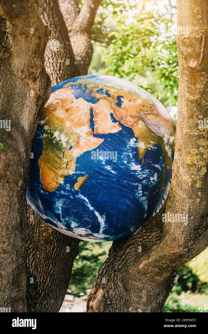 A large, inflatable globe of the Earth is nestled securely among the ...