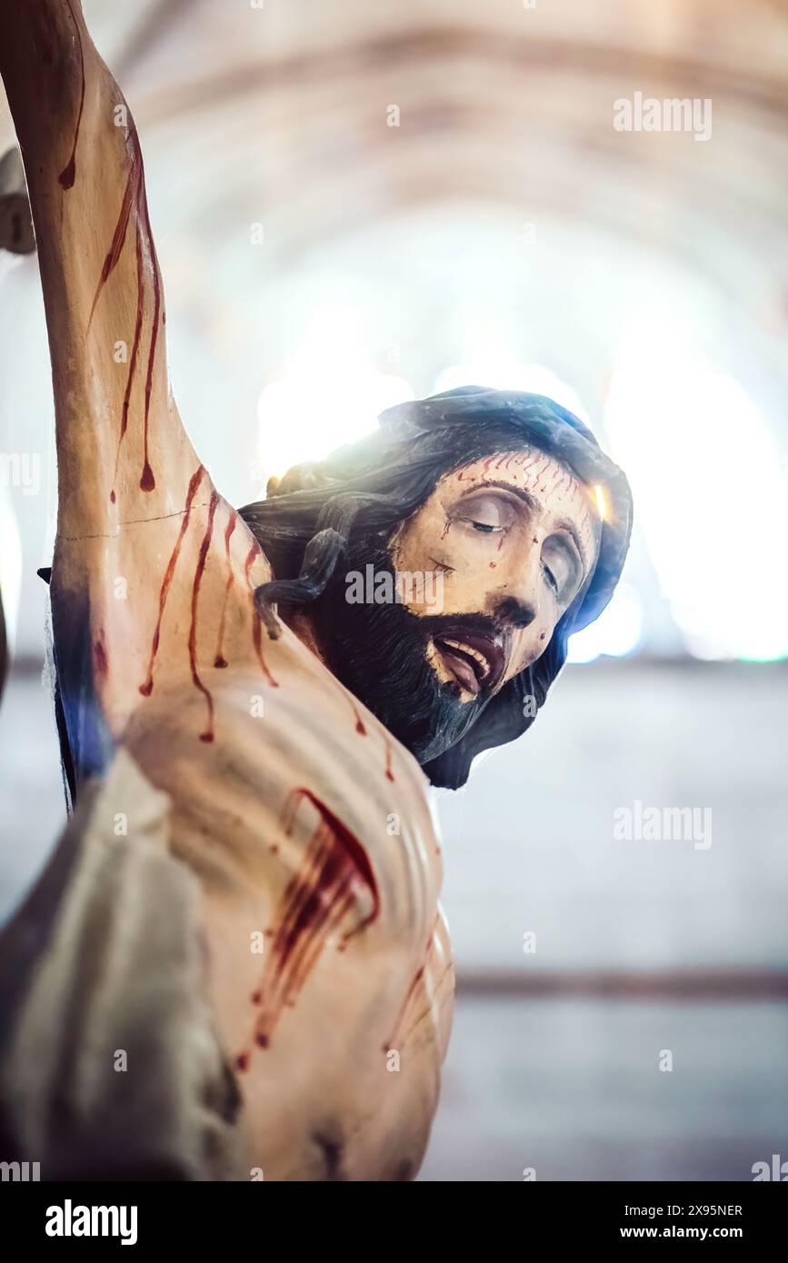 This detailed close-up captures a crucifix statue inside a historic ...
