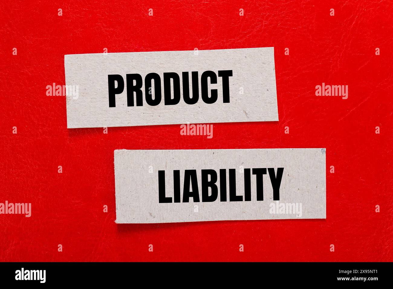 Product liability words written on paper pieces with red background ...