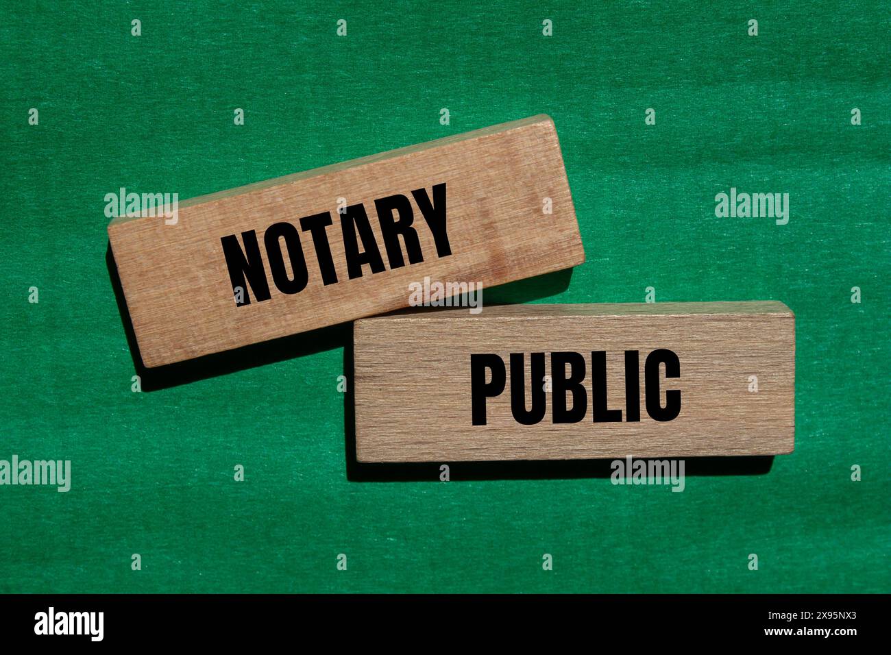 Notary public words written on wooden blocks with green background ...