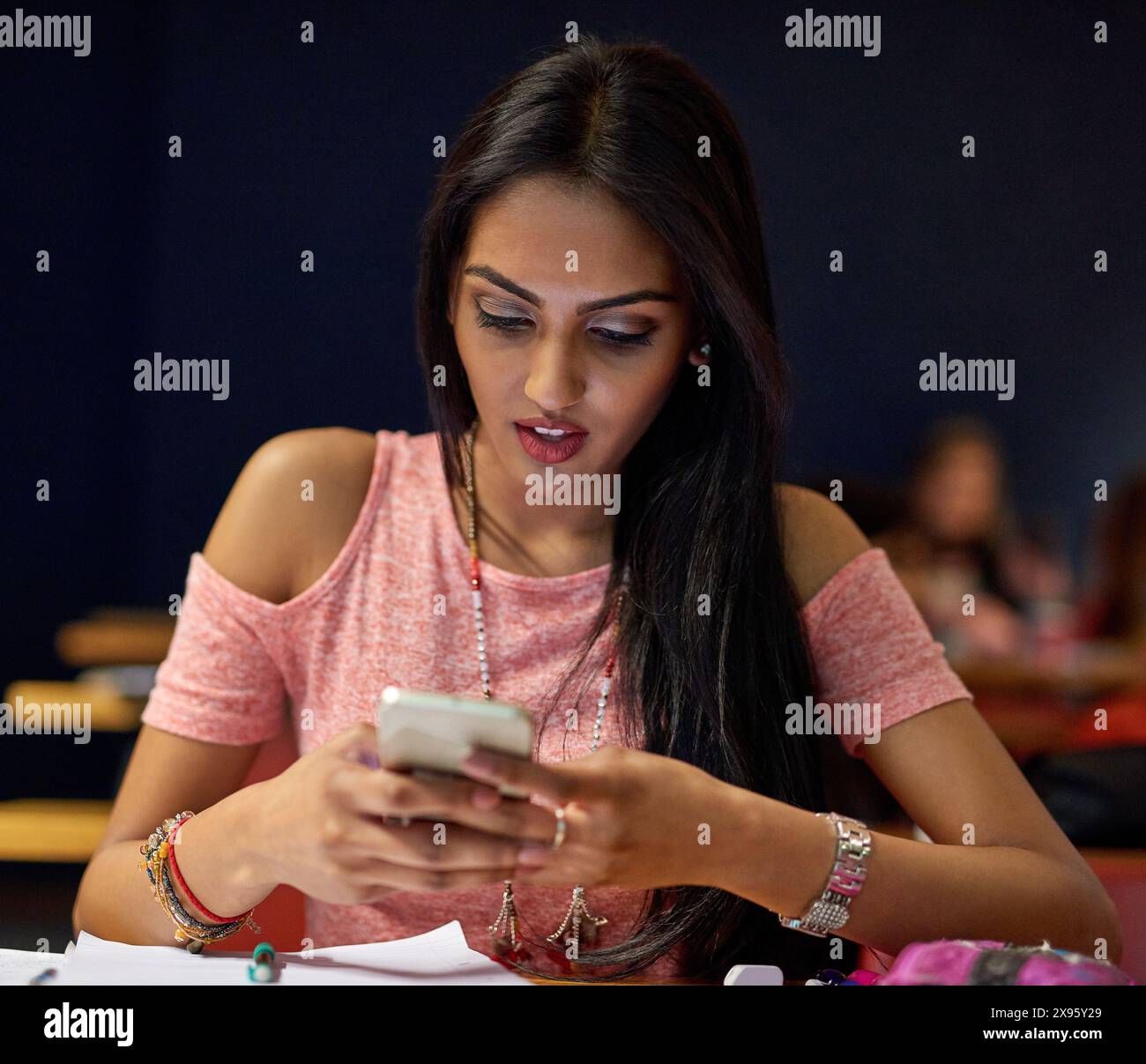 Indian woman, lecture hall and browsing smartphone for research, notes ...