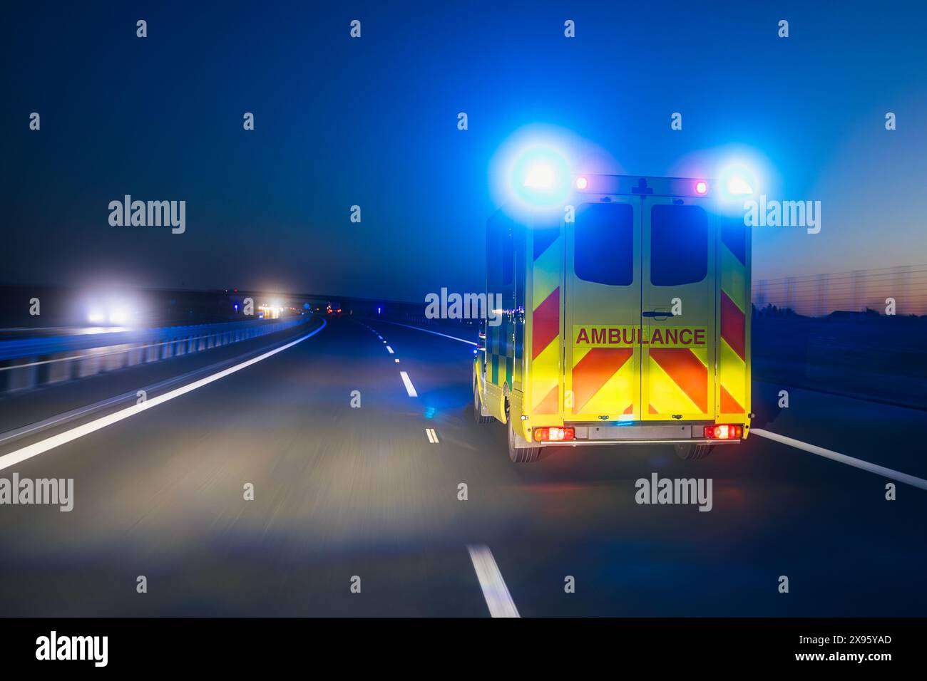 Fast moving ambulance car of emergency medical service on highway at ...