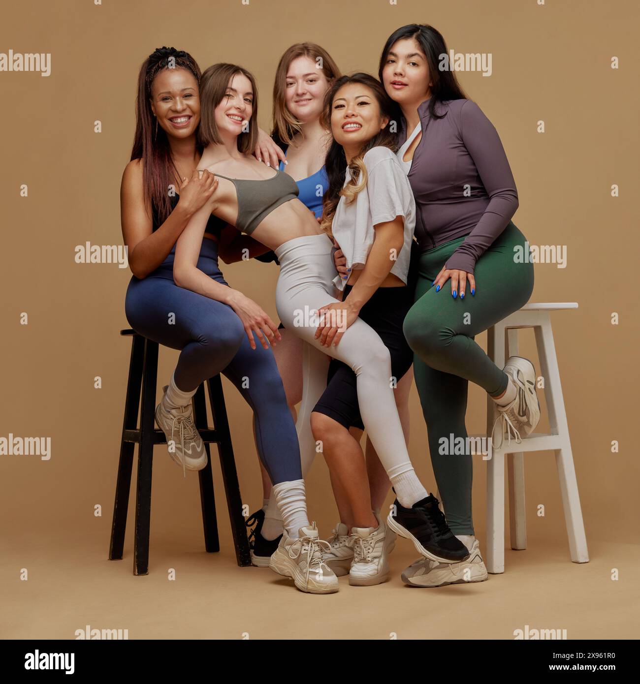 Positive, beautiful woman of different races and sizes posing together ...