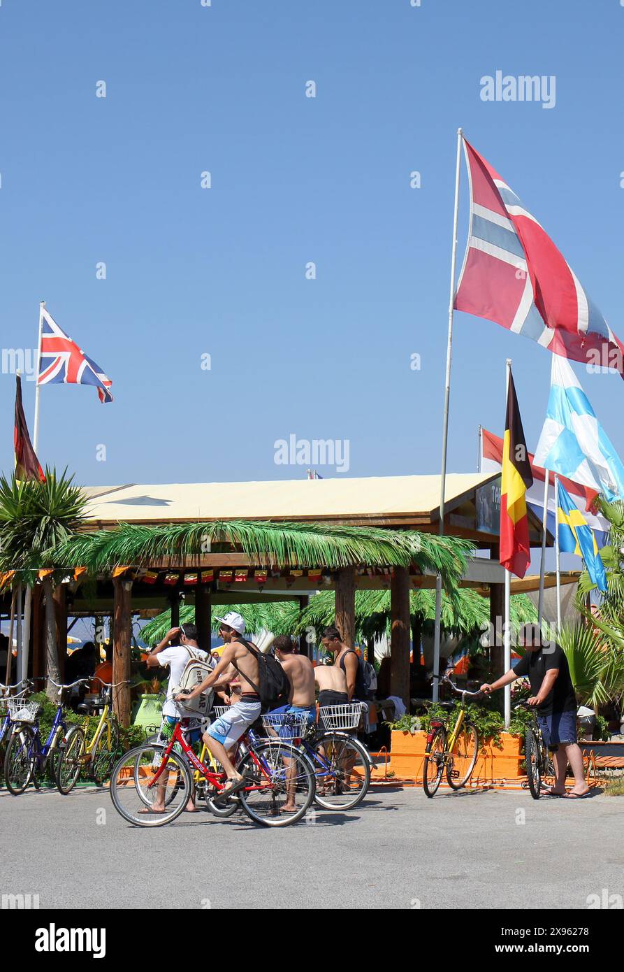 KOS, GREECE-JULY 07,2011:Unidentified Tourists with Bicycles in front ...