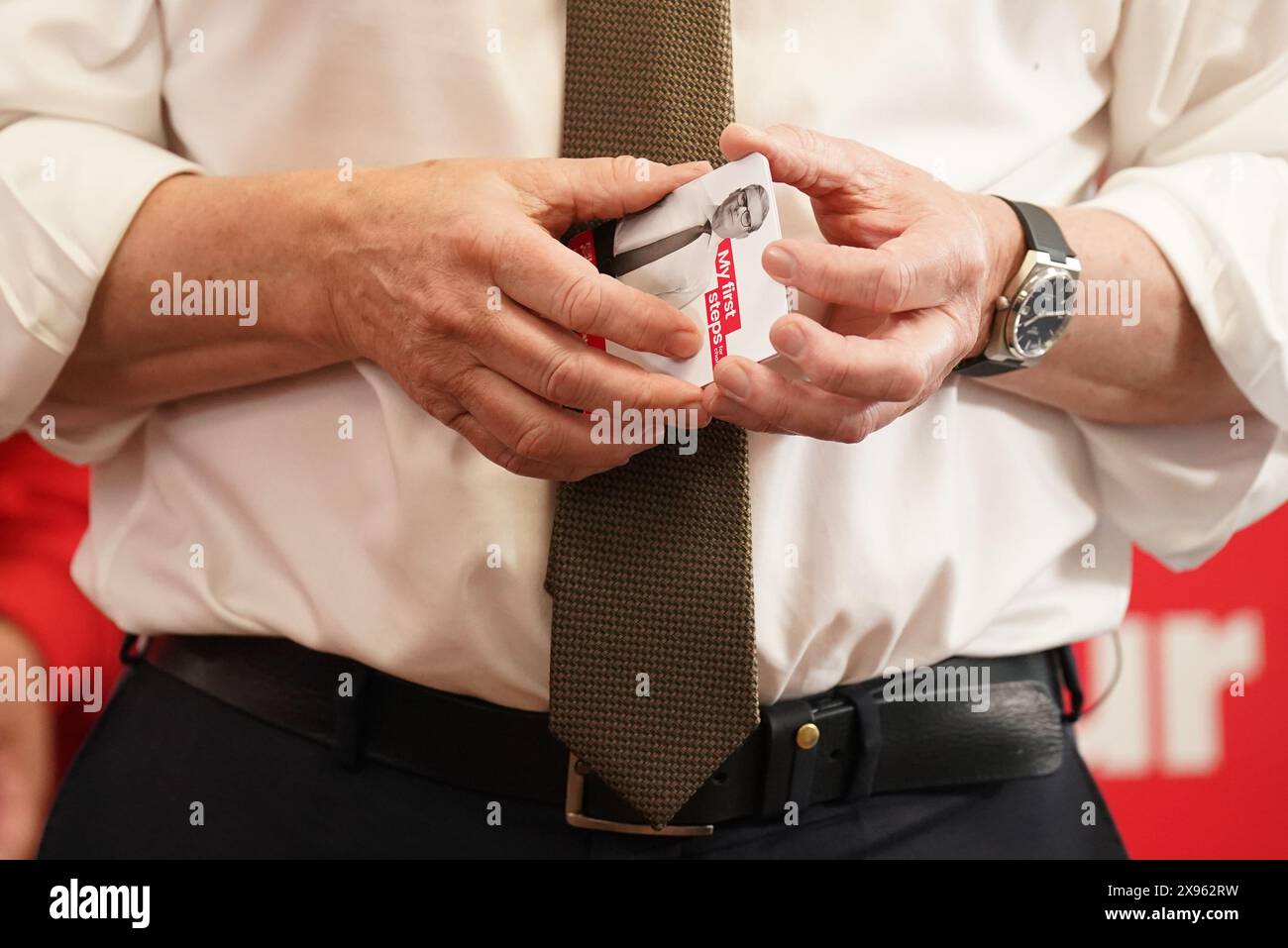 Labour Party leader Sir Keir Starmer holds a Labour pledge card during ...