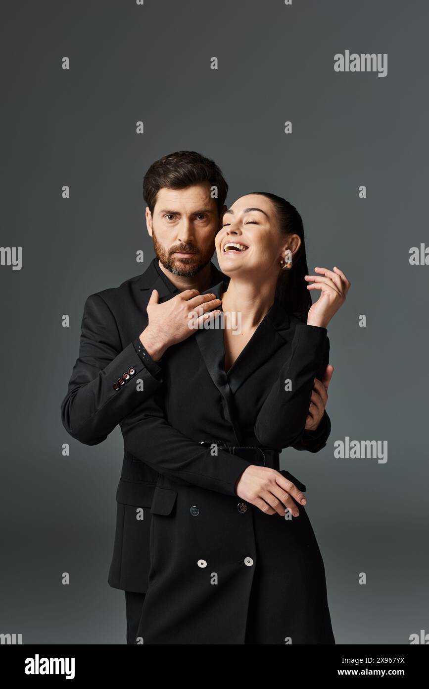 A man and a woman, dressed elegantly, embrace each other Stock Photo ...