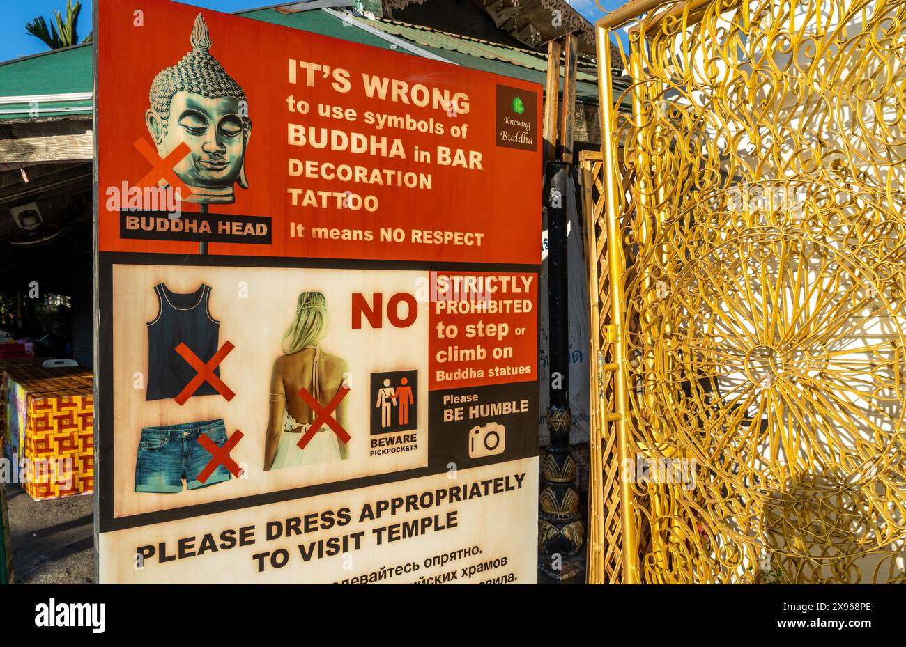 Tourist sign asking for appropriate behaviour outside a Buddhist temple ...