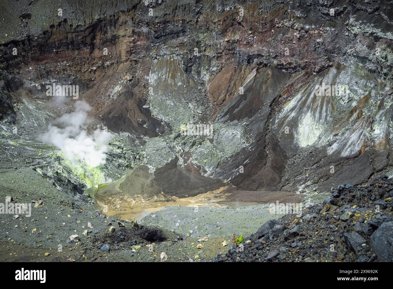 Sulphurous fumaroles and volcanic strata in Tompaluan active crater on ...