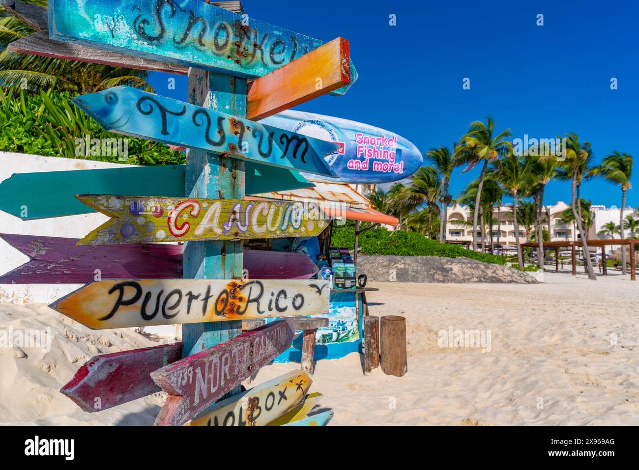 View of colourful destination sign on beach at Puerto Morelos ...