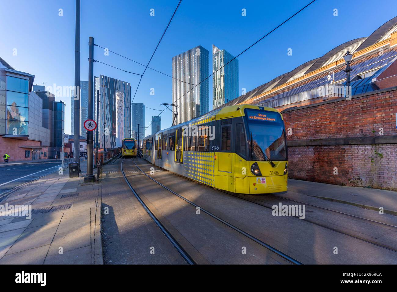View of apartment buildings, city tram and Tower Of Light, Manchester ...