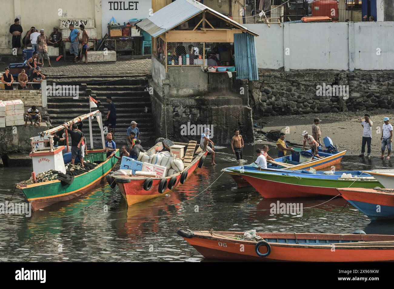 Colourful wooden ferry boats on the waterfront in the port of this ...