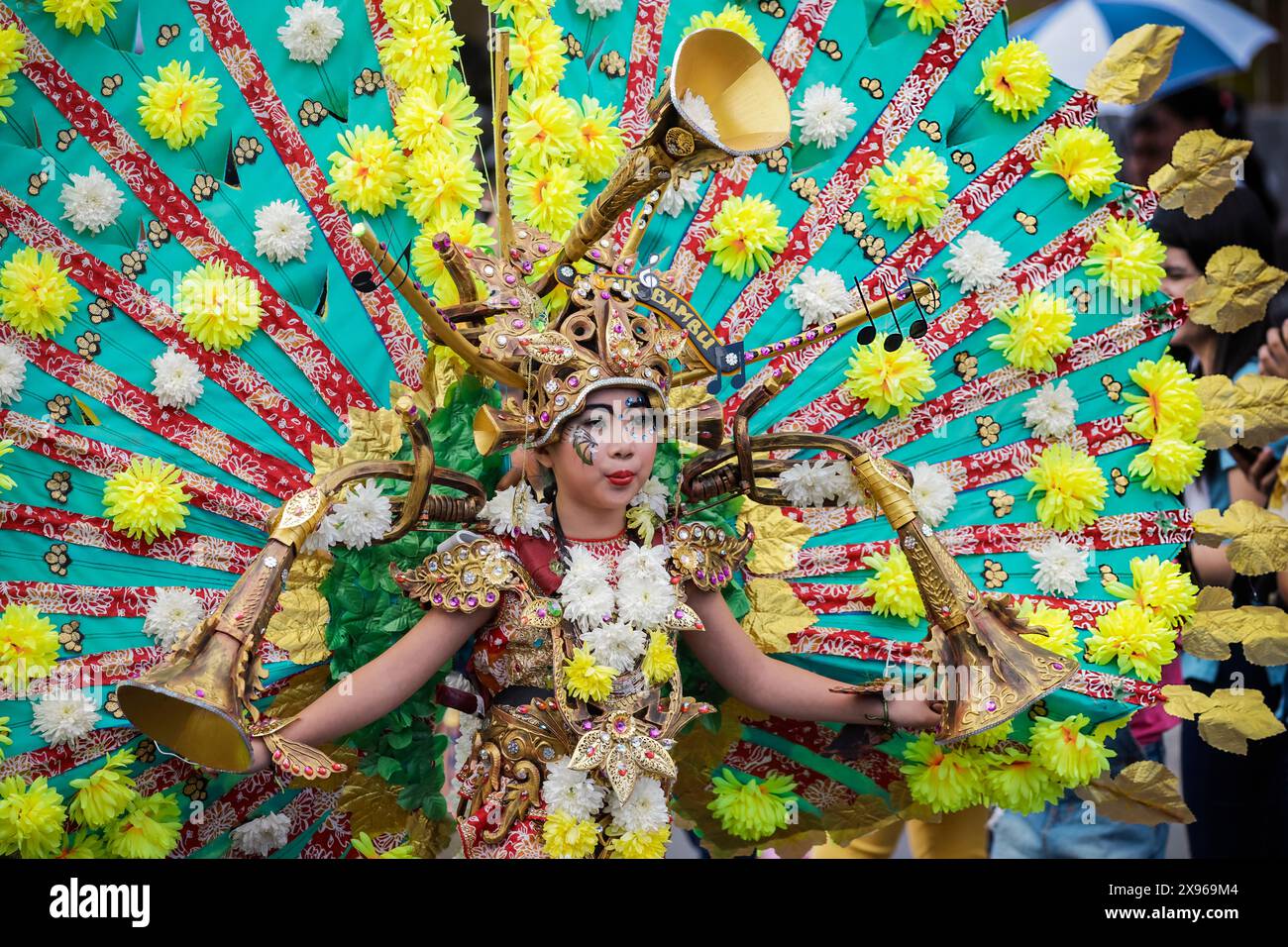 Girl in elaborate peacock style costume at the annual Tomohon ...