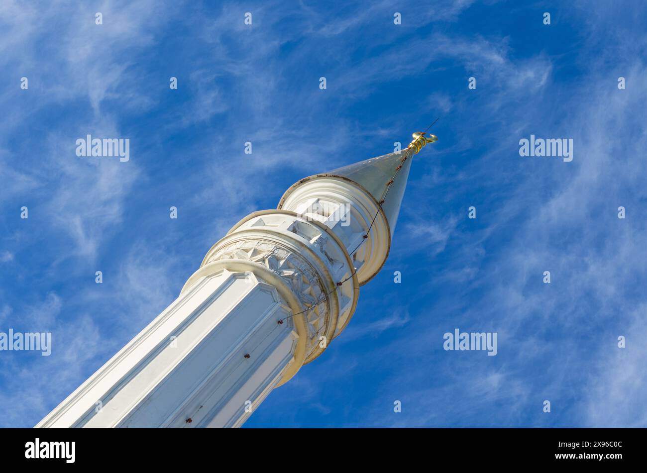 Shot from the Dutch angle of a stylized minaret reaching into the sky ...