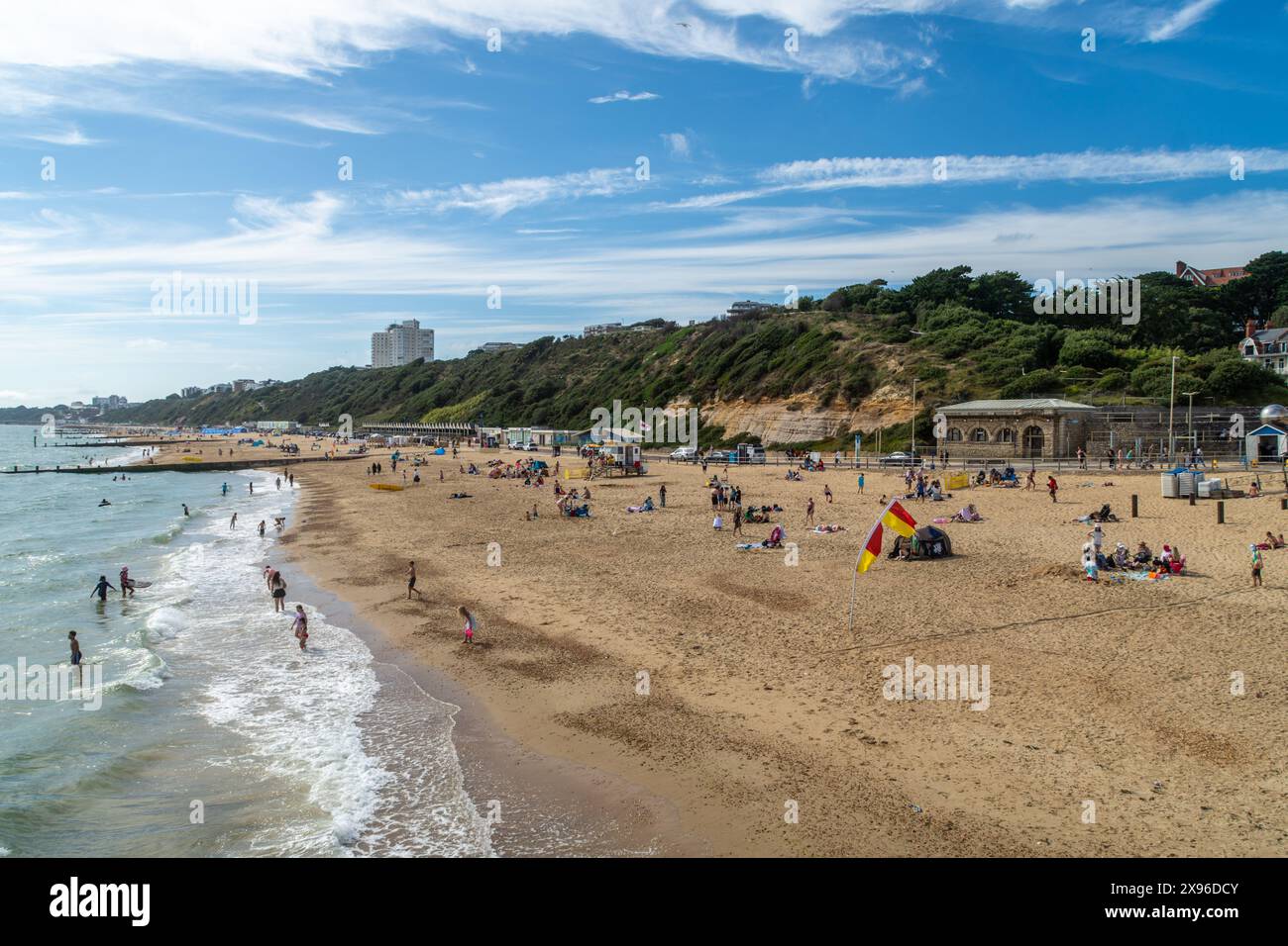 Boscombe, UK - August 11th 2023: RNLI safety flag amongst sunbathers on ...