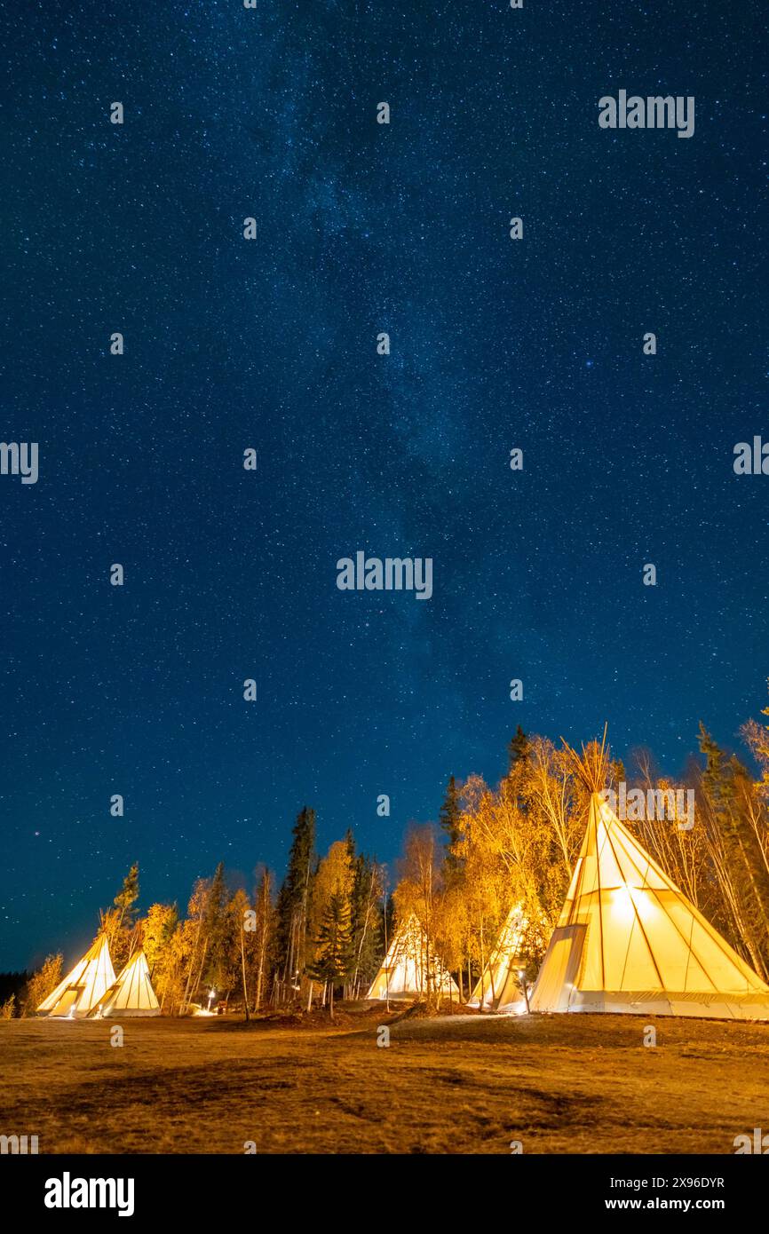 Amazing starry night sky and milky way galaxy over the light up Tipi or ...