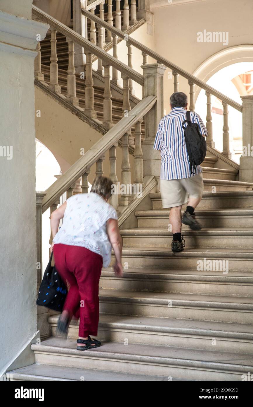 Two people climb the historic Imperial staircase designed by Juan de ...