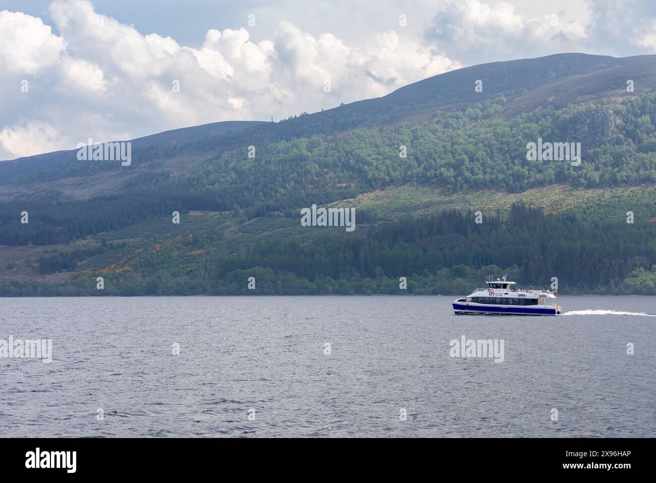 A tour boat plies the waters of Loch Ness in the Scottish Highlands of ...