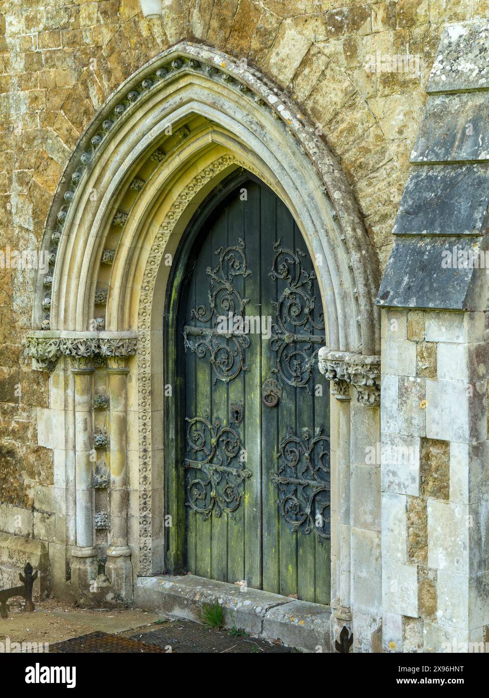 Old, ornate pointed Gothic arch church door with fleuron decorated ...