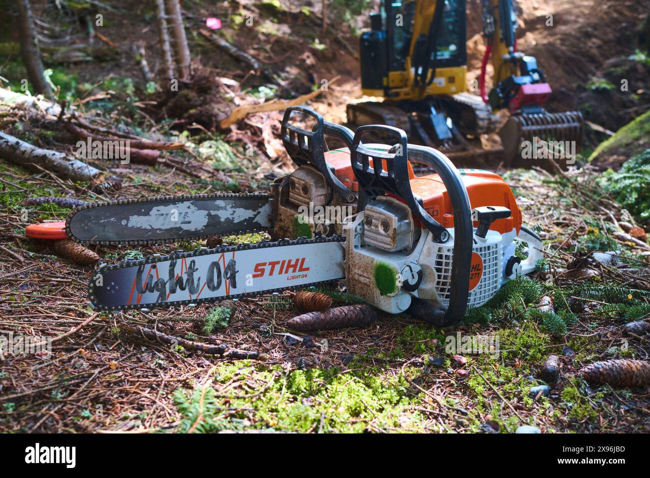 Two Stihl chainsaws on mossy forest floor, one new, one old Stock Photo ...