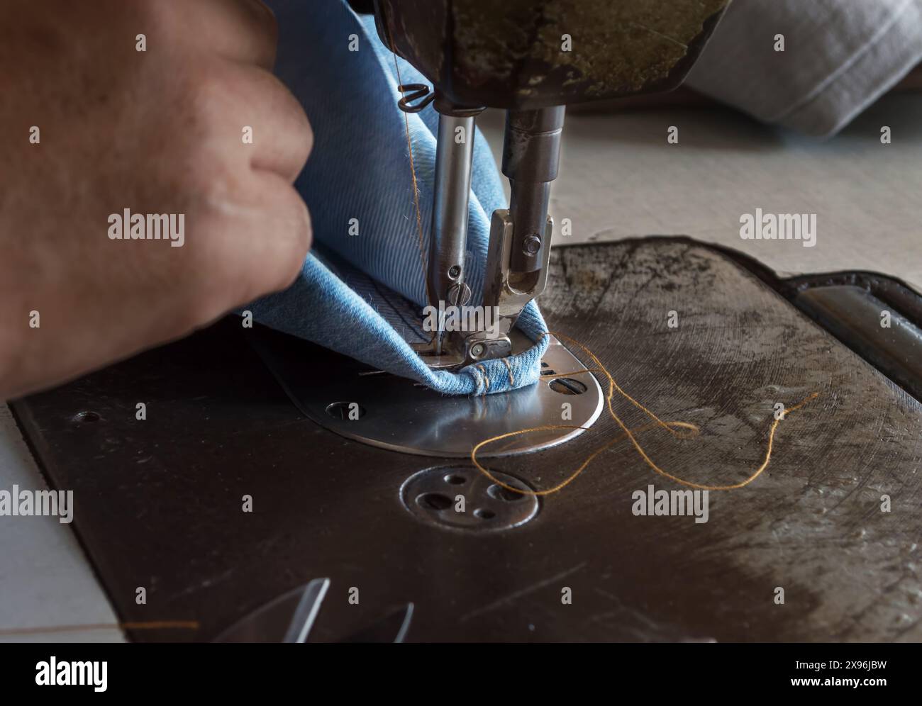 Woman hands sewn fabric repairs on sewing machine in Sewing Process ...