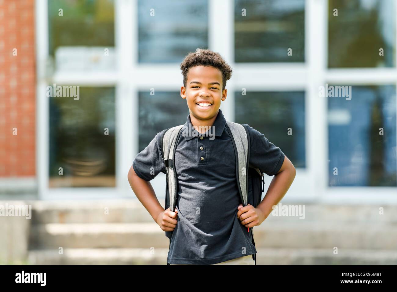Smiling african american school boy with backpack Stock Photo - Alamy