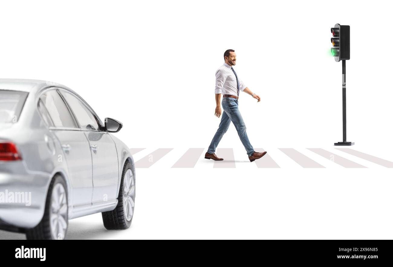 Full length profile shot of a man walking at a pedestrian crossing in ...