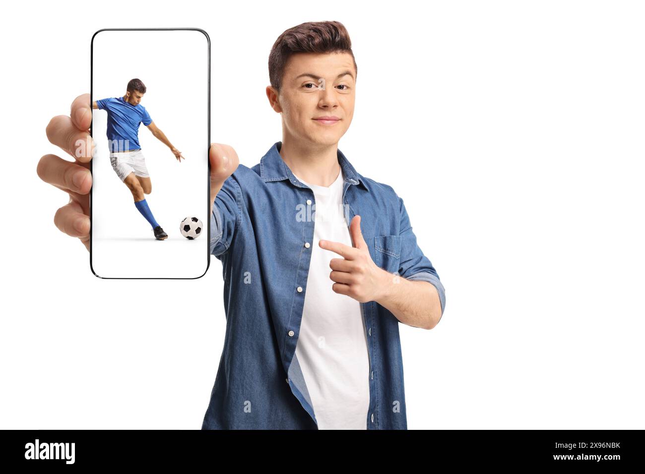 Teenager holding a smartphone with a football player kicking a ball on ...