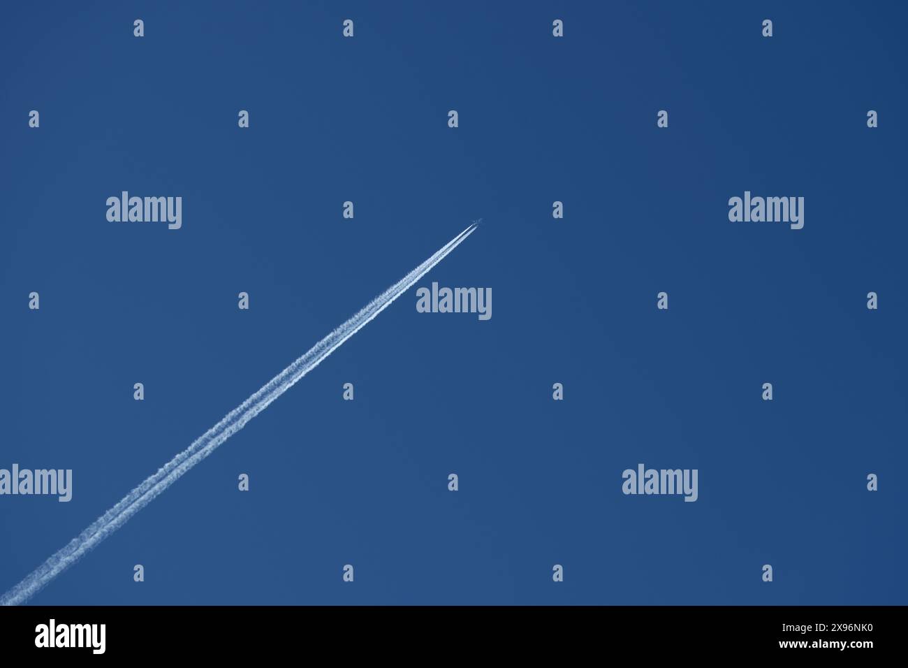 Airplane trails in the blue sky. Airplane trail on blue sky Stock Photo ...