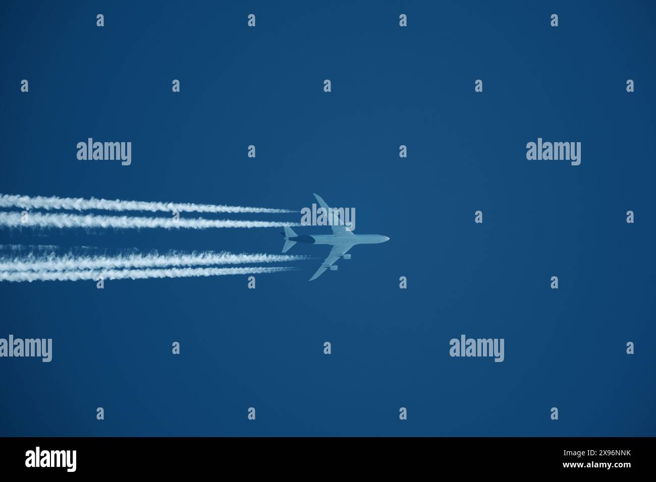 Airplane trails in the blue sky. Airplane trail on blue sky Stock Photo ...