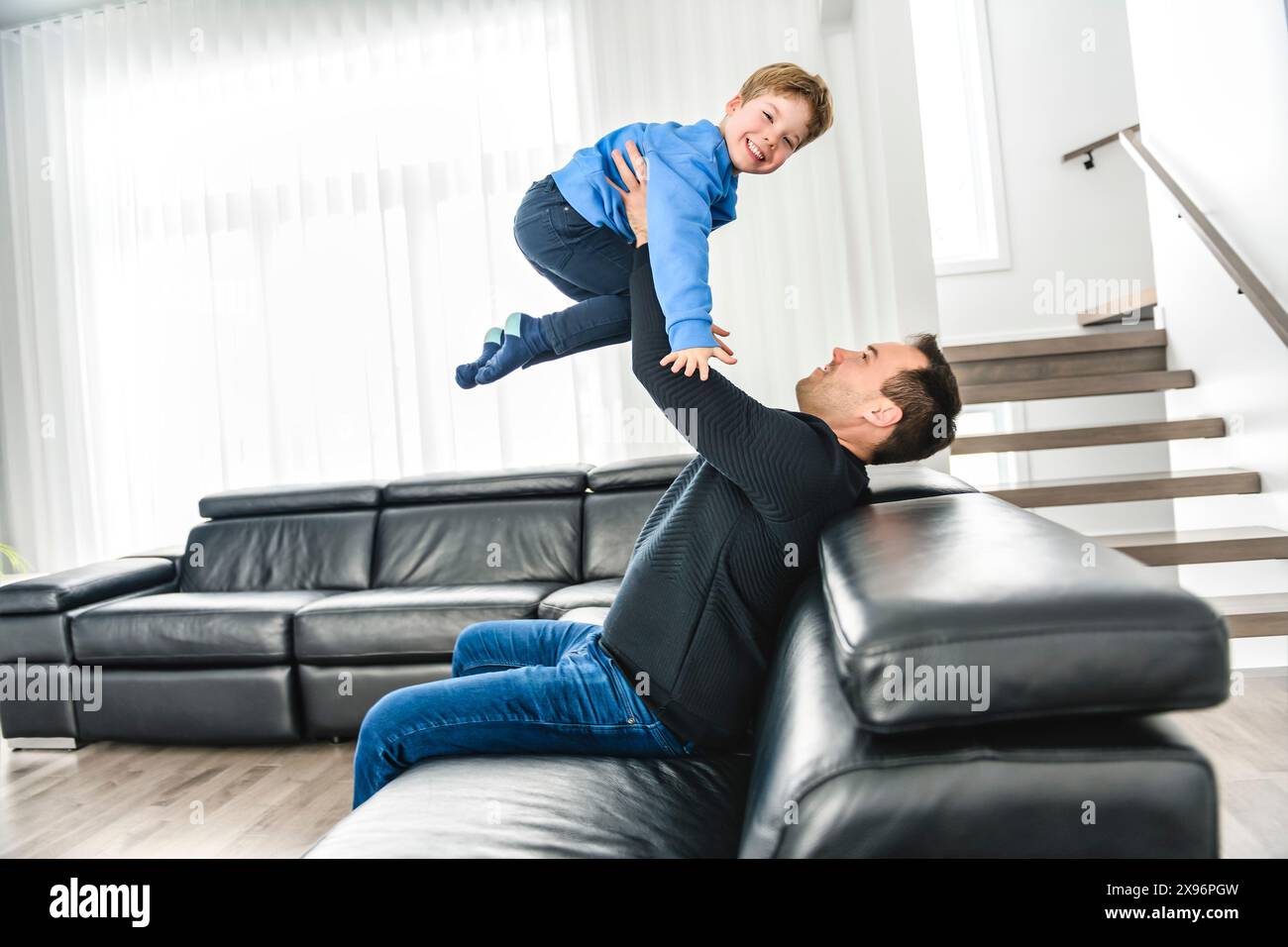 Dad with his cute little boy on a modern house Stock Photo - Alamy