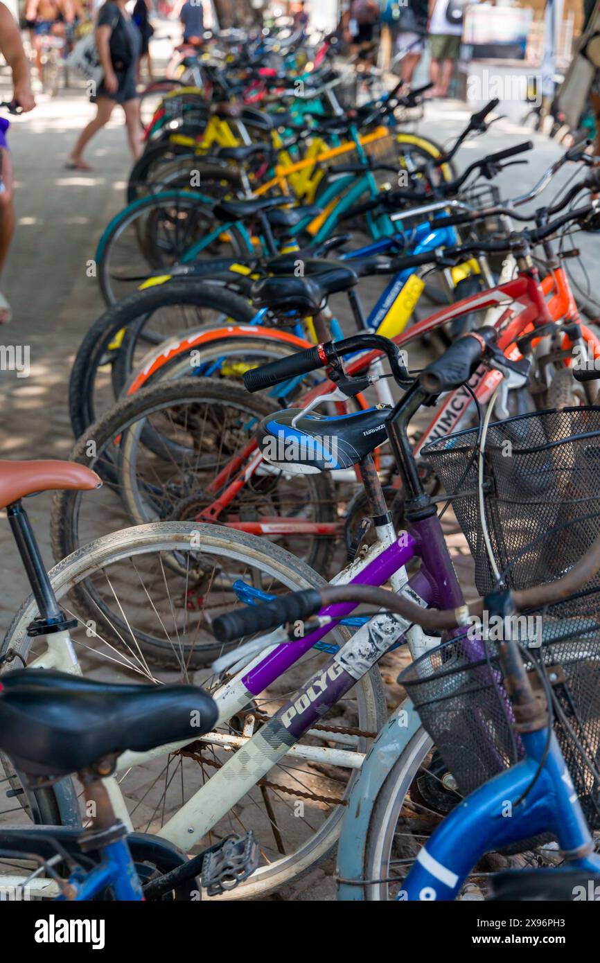 Rental bicycles on the main street of Gili Trawangan in Indonesia. The ...