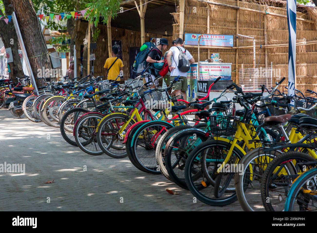 Rental bicycles on the main street of Gili Trawangan in Indonesia. The ...
