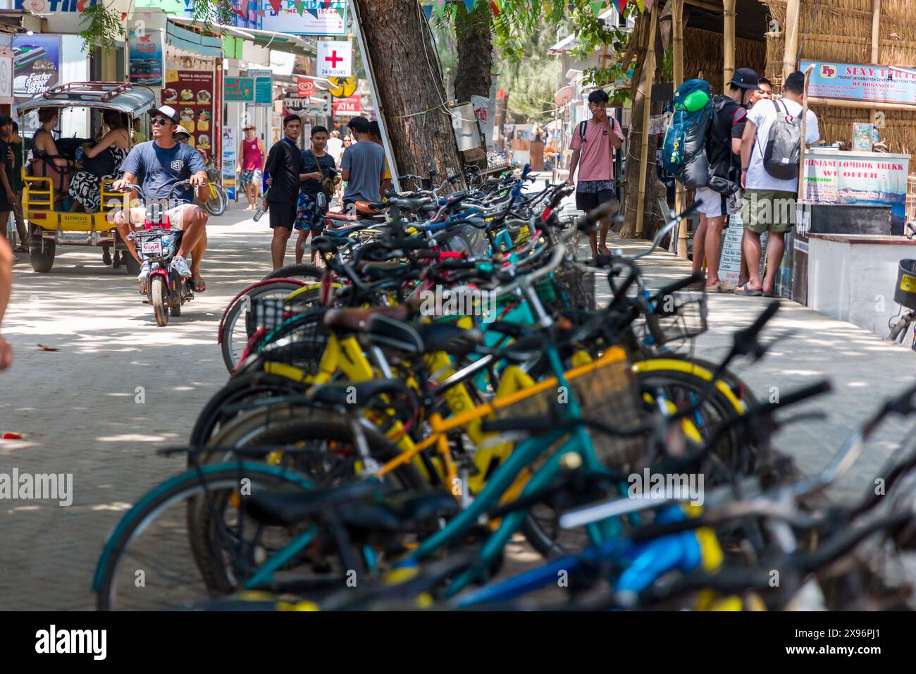 Rental bicycles on the main street of Gili Trawangan in Indonesia. The ...