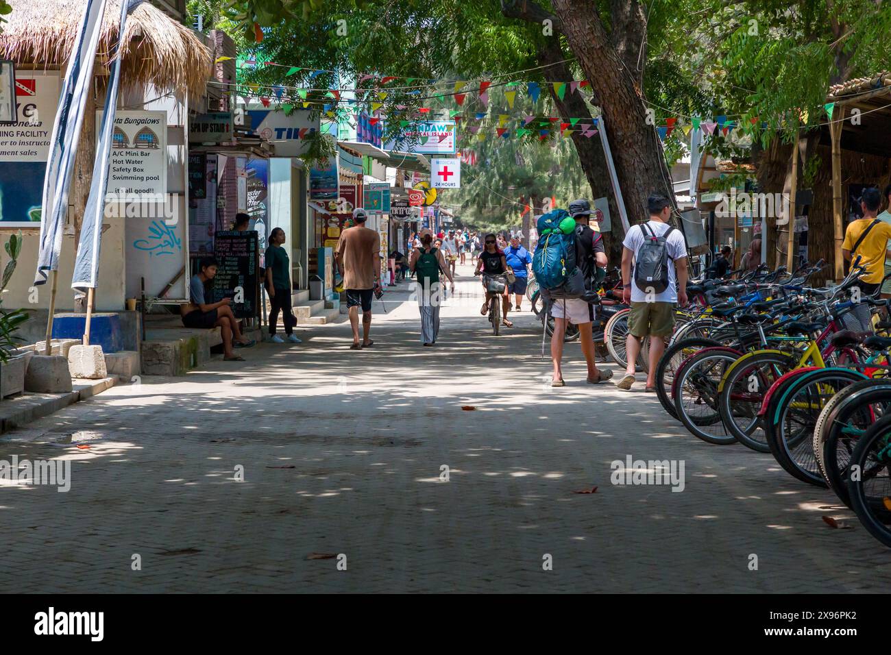 Rental bicycles on the main street of Gili Trawangan in Indonesia. The ...