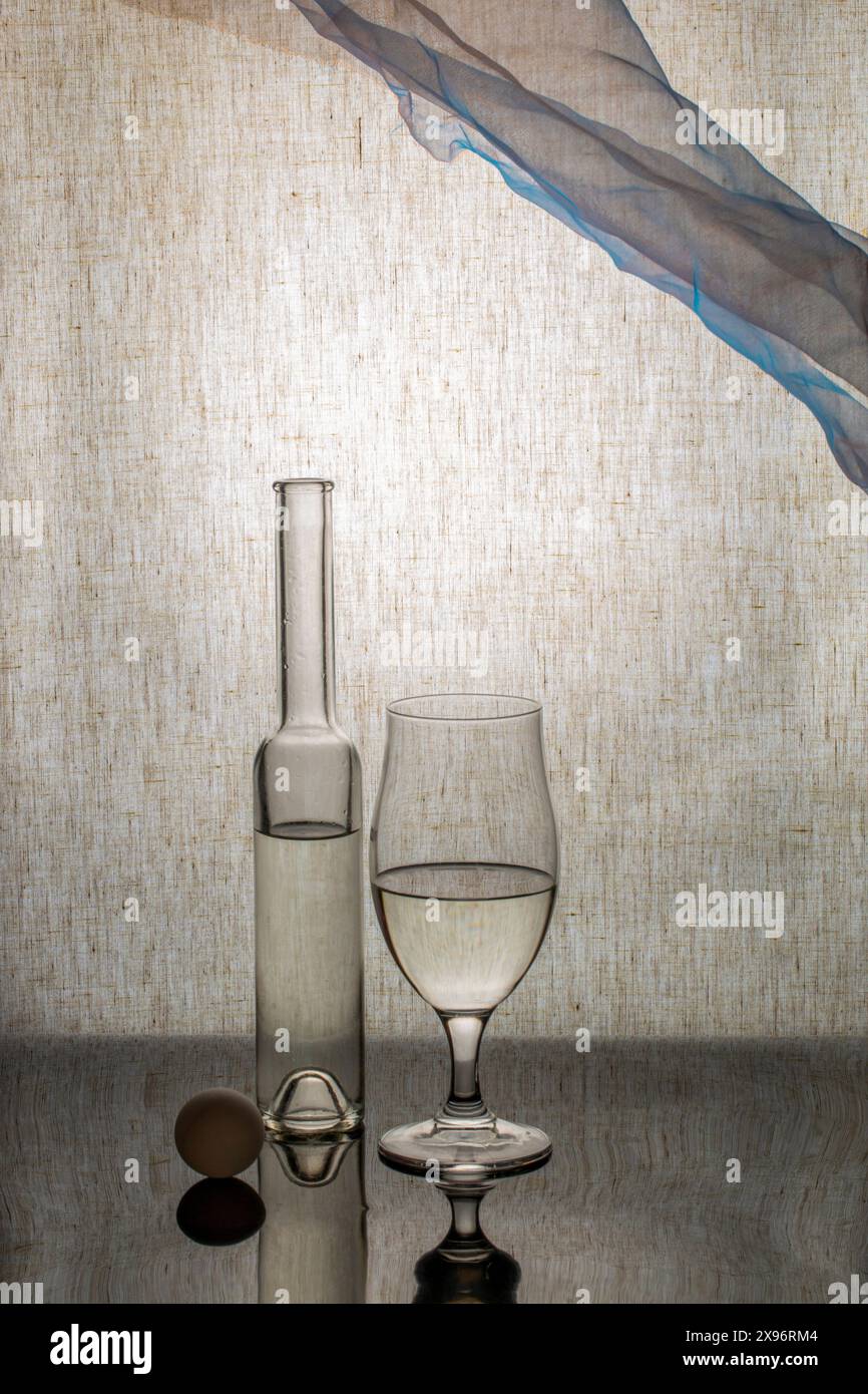 Still life with glassware and transparent cloth Stock Photo - Alamy