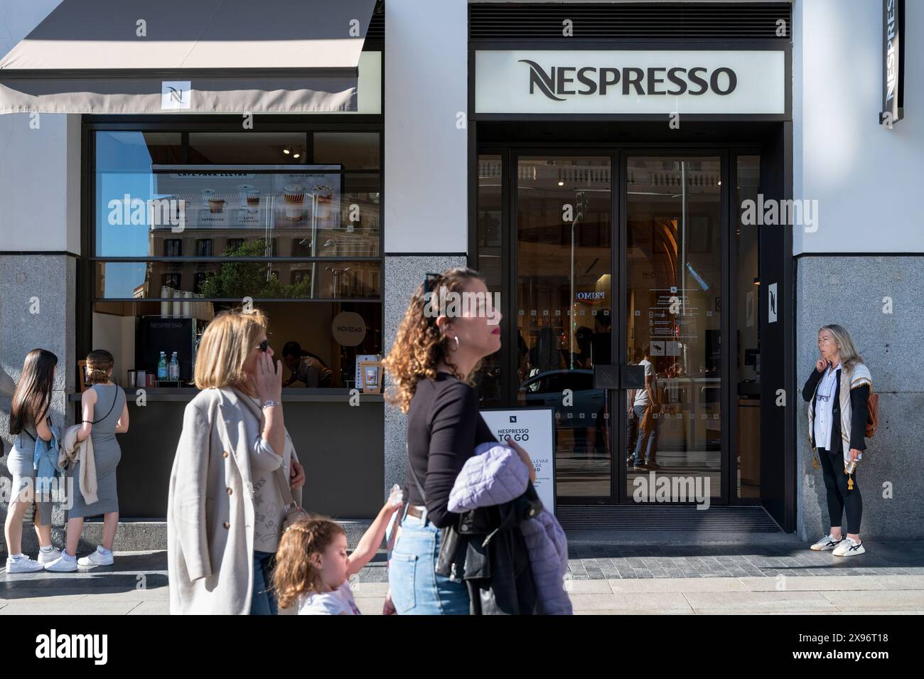 People walk past the Swiss high-end and world leader in coffee capsules ...
