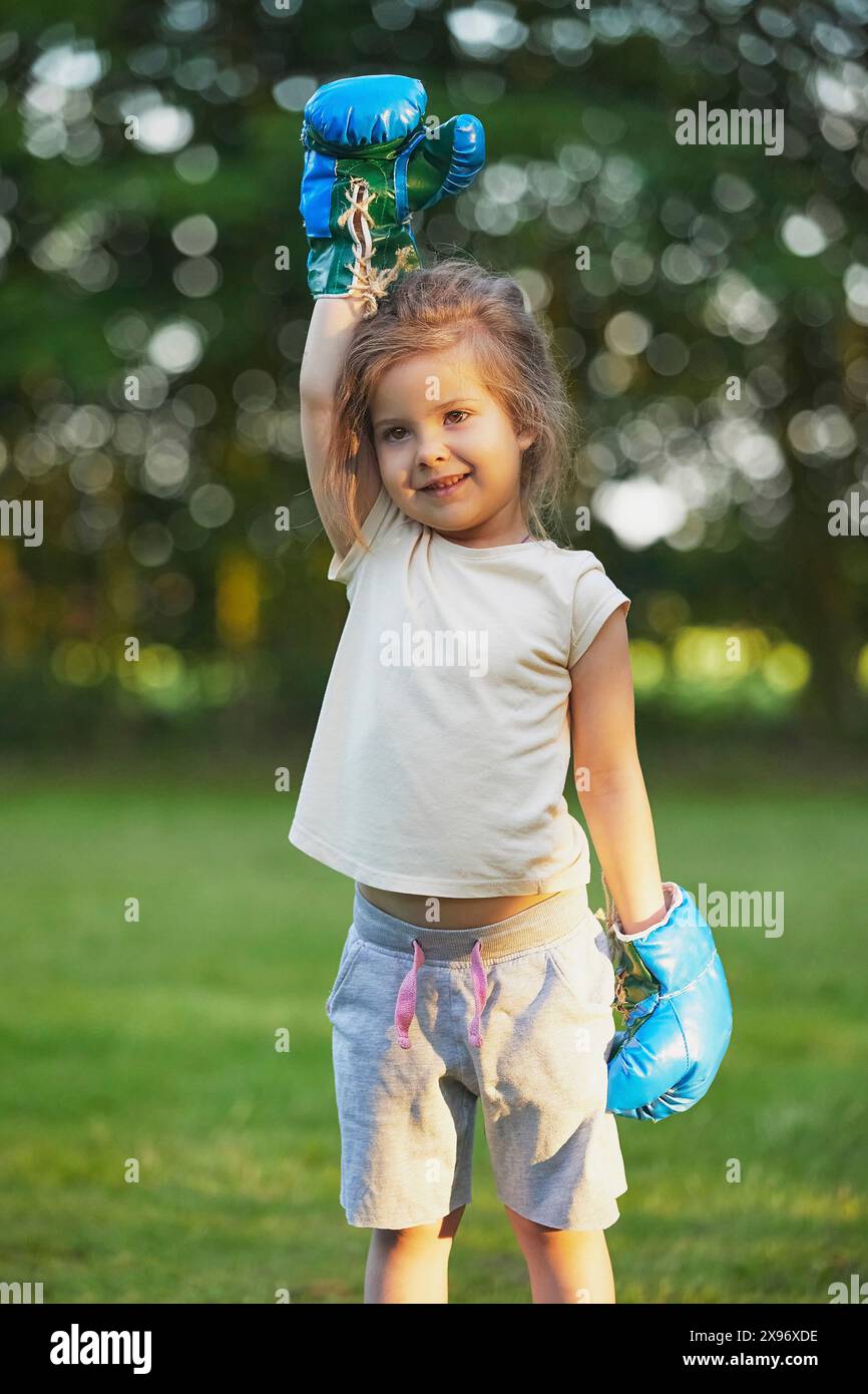 Charming child doing boxing in the backyard on the Sunset Stock Photo ...