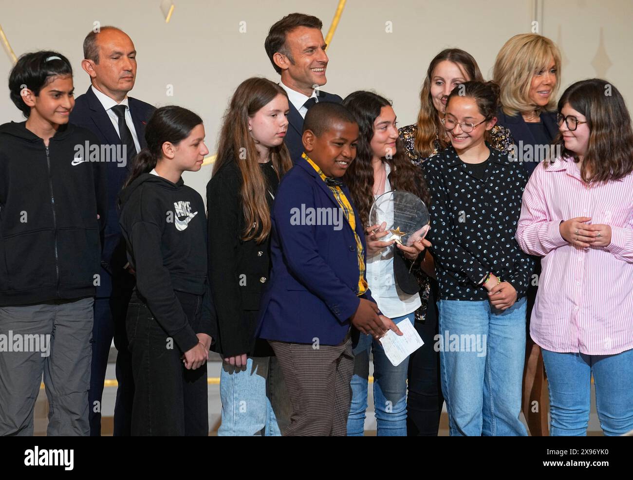 French President Emmanuel Macron, back row center, and his wife ...