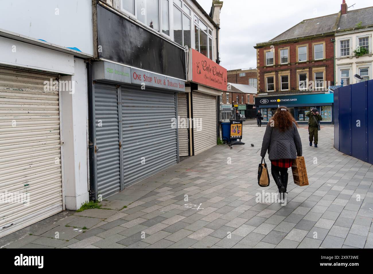 Blyth, Northumberland, UK. 29th May 2024. Shoppers next to shuttered ...