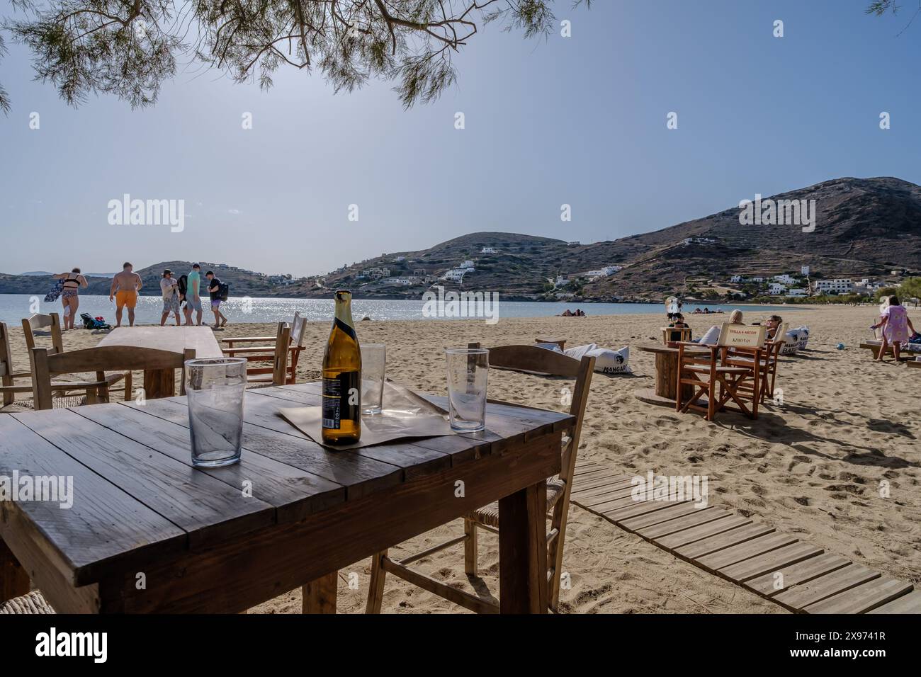 Ios, Greece - May 2, 2024 : View of a tables, chairs and tourists ...