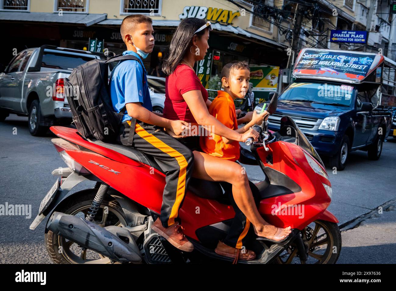 Two Thai school kids heads home on a scooter in Pattaya Thailand ...