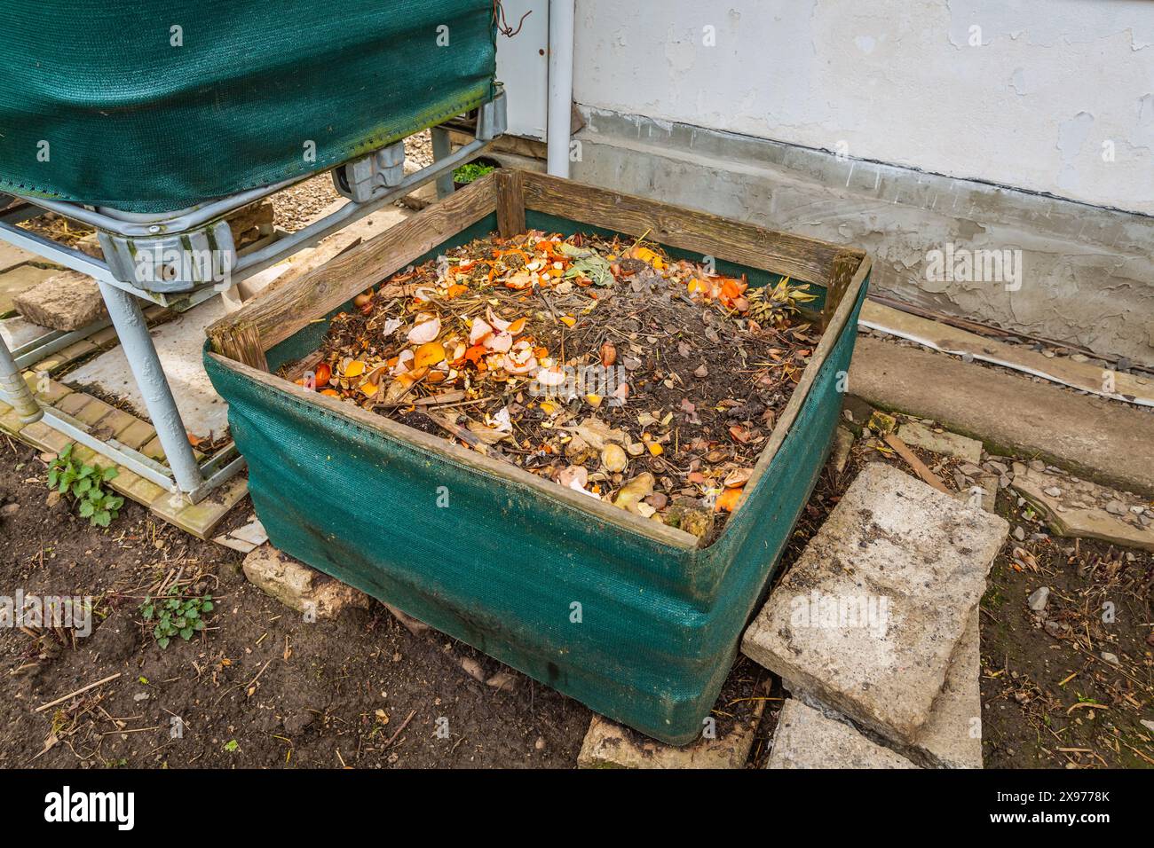 Compost bin in a garden, using kitchen and green waste to prepare ...