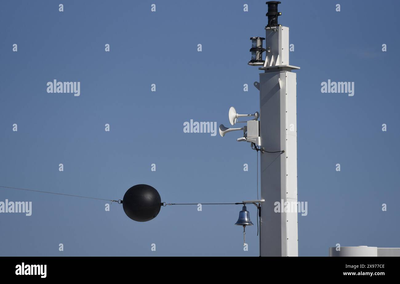 View of an anchor ball, dual horns and a ship's bronze bell on the ...