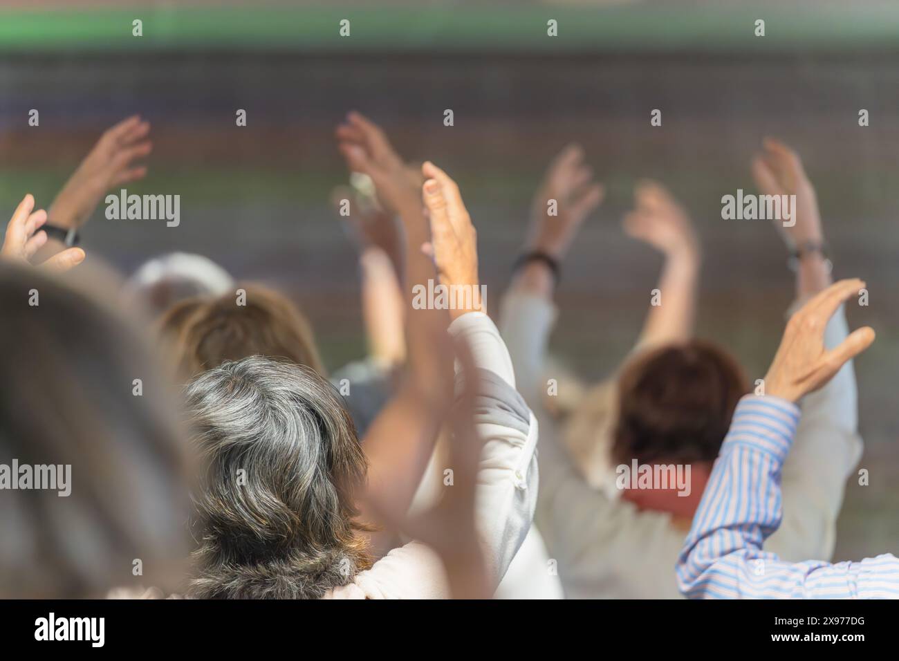 Group of older people raising their arms in a meditation class Stock ...